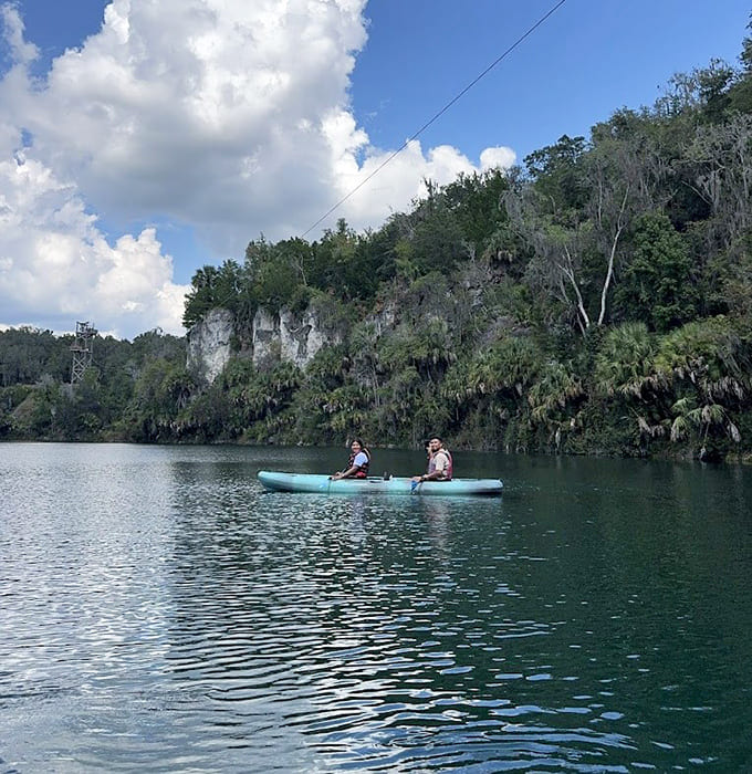 Kayaking the crystal-clear waters between canyon walls, where paddling feels like exploring a secret world hidden in plain sight.