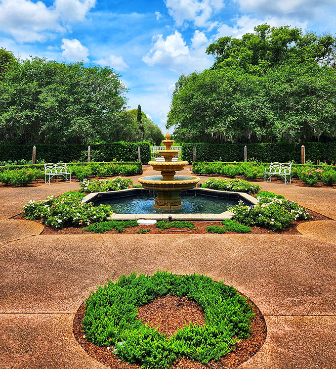 The formal garden's tiered fountain creates a peaceful focal point, surrounded by meticulously maintained plantings and inviting benches.