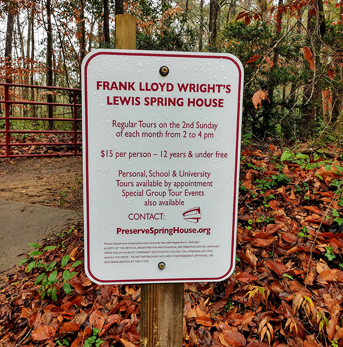 The informational sign stands sentinel, inviting curious souls to discover Wright's hidden Florida masterpiece on monthly guided tours.