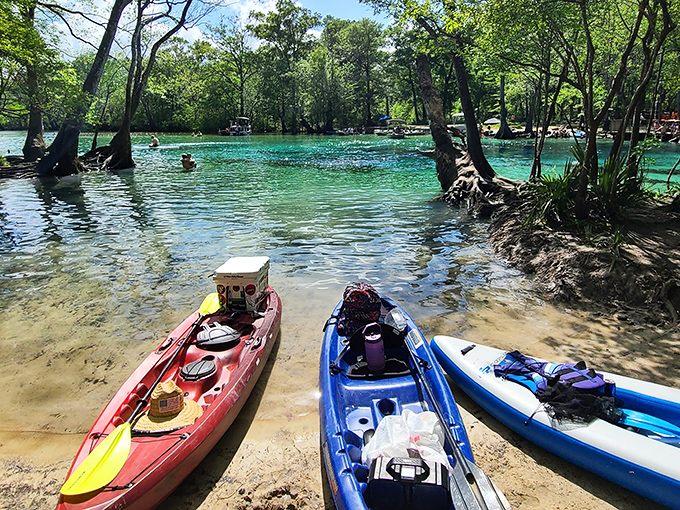 Kayaks resting at the spring's edge &ndash; temporary parking spots for those who've traded traffic jams for floating in nature's embrace.