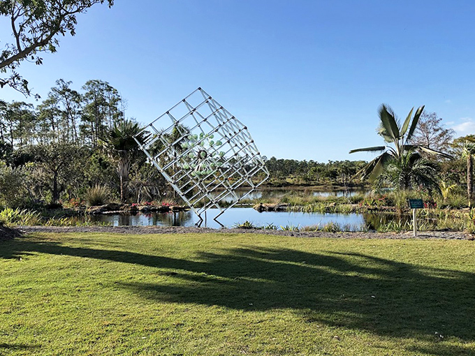 A geometric sculpture seems to emerge from the water, creating an optical illusion that challenges perception.