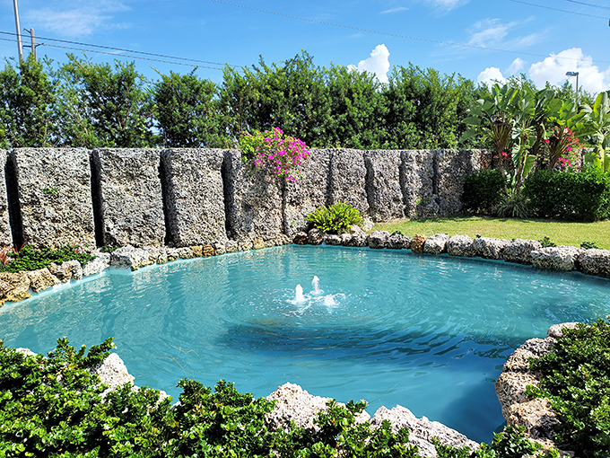 The crystal-clear pool reflects the Florida sky, surrounded by coral walls that seem to whisper secrets from another time.