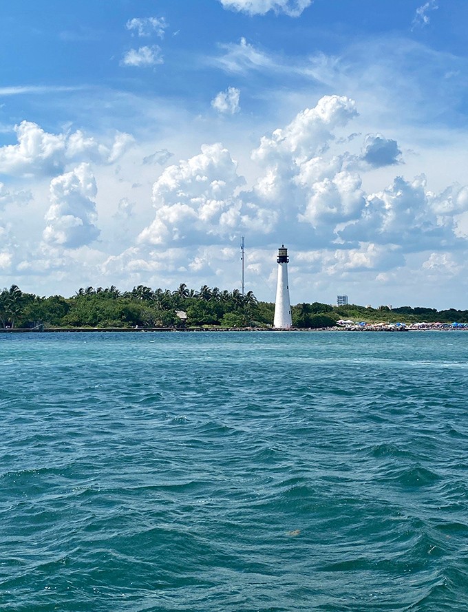 The Cape Florida Lighthouse stands sentinel nearby, its white tower a navigational beacon for those seeking Stiltsville's hidden charms.