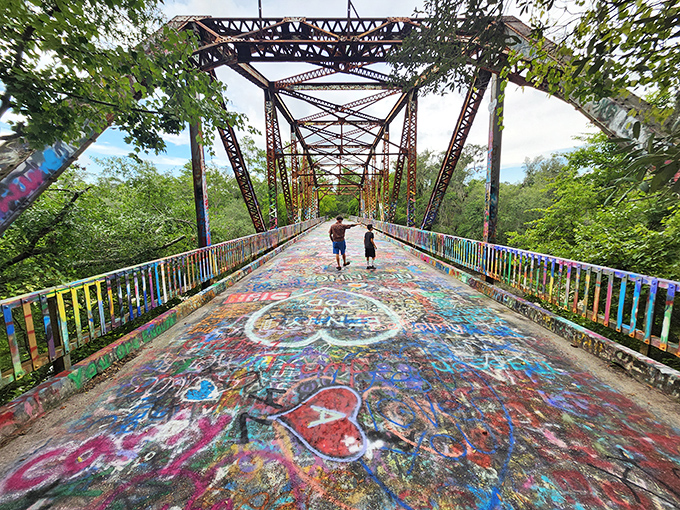 Explorers discover their own meanings among the layers of paint, each visitor experiencing a unique connection to this collaborative creation.