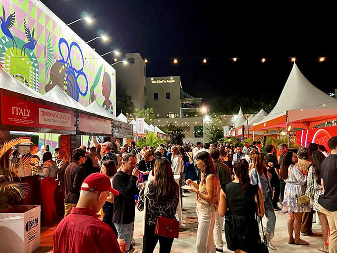 Evening lights illuminate the festival entrance to Italy's pavilion, where pasta dreams and wine wishes come true for lucky visitors.