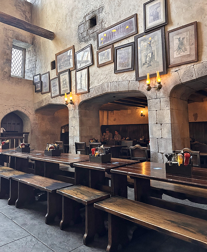Weathered stone walls adorned with framed wizarding memorabilia create an atmosphere of ancient magic and timeless stories.