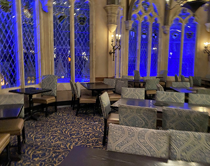 As evening falls, the dining room transforms into a jewel box of color, with stained glass windows glowing like precious gems.