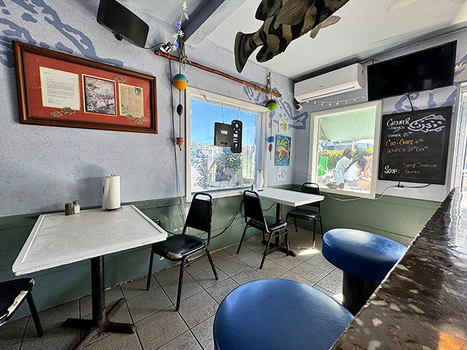 The dining room at Dockside Dave's embraces coastal charm with its sea-blue accents and fishing memorabilia &ndash; unpretentious perfection for serious seafood enjoyment.