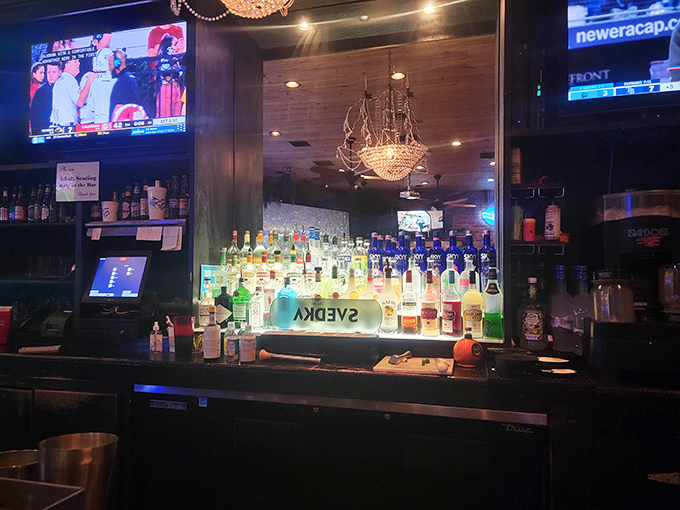 Backlit bottles glow like amber treasures, promising libations to complement those famous smoked wings.