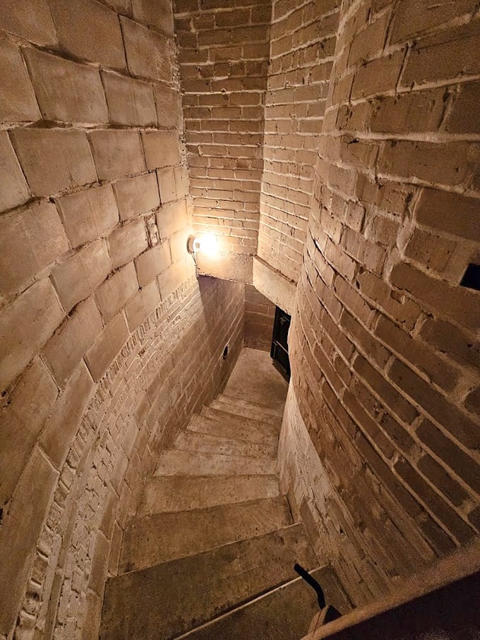 Not all staircases lead to grand ballrooms &ndash; this narrow basement passage hints at the mansion's Prohibition-era mysteries.