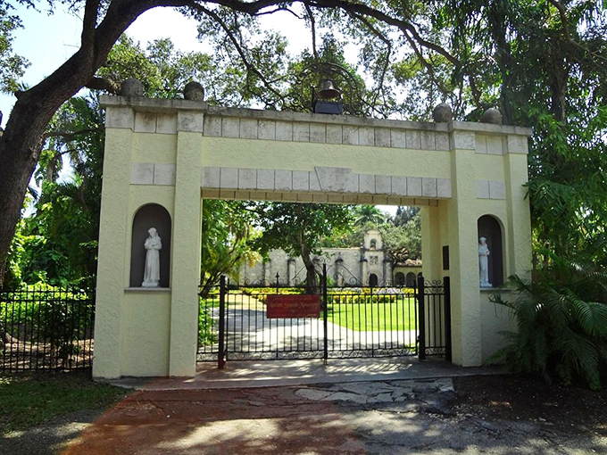 The entrance gate welcomes visitors with a blend of medieval gravitas and tropical landscaping&mdash;history's most unexpected mashup.