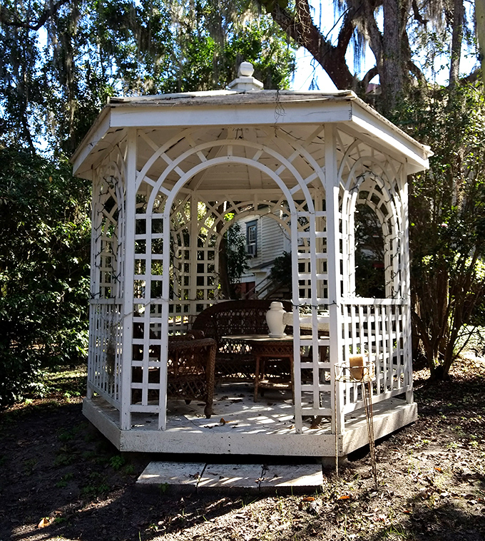 A charming white gazebo nestled among the trees offers a quiet retreat for contemplation&mdash;or perhaps communion with spirits of the garden.
