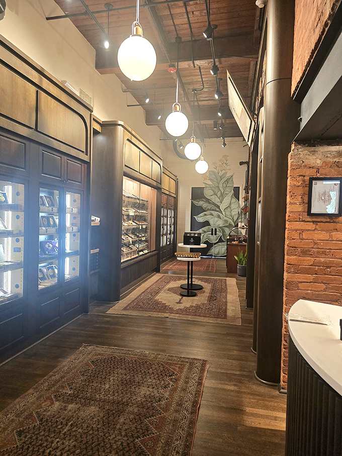 Elegant lighting illuminates the path through cigar history. These hallways connect more than just rooms&mdash;they bridge past and present.