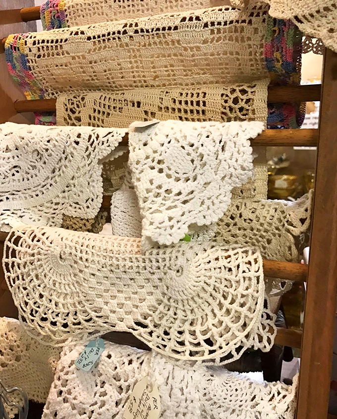 Handcrafted doilies and lace runners represent countless hours of patient handiwork, each intricate pattern preserving a tradition nearly lost to time.