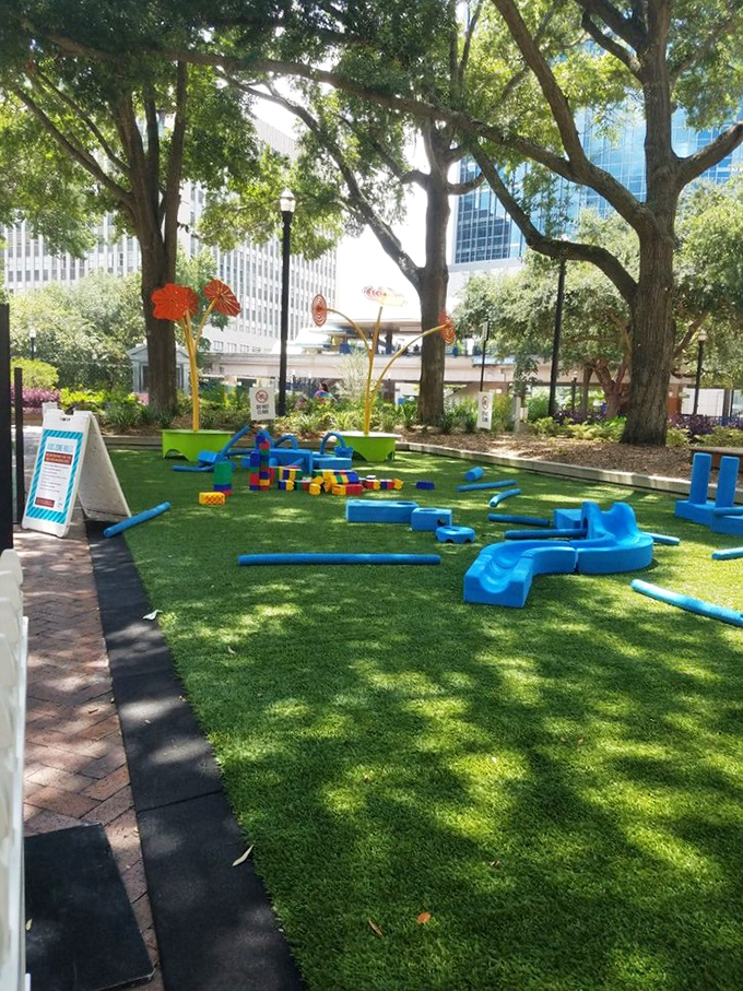 The children's play area features bright blue equipment on artificial turf &ndash; a safe haven for little adventurers to conquer while parents catch their breath.