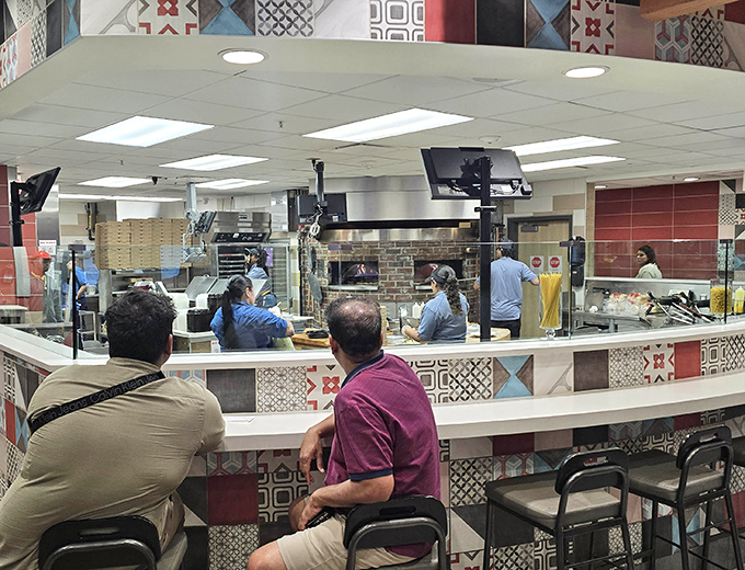 Open kitchen concept where burgers meet Broadway&mdash;watch the culinary choreography of your meal coming together.