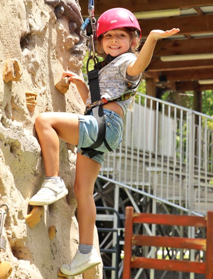 Little daredevils test their mettle on this climbing wall, proving that sometimes the most memorable adventures happen on solid ground.