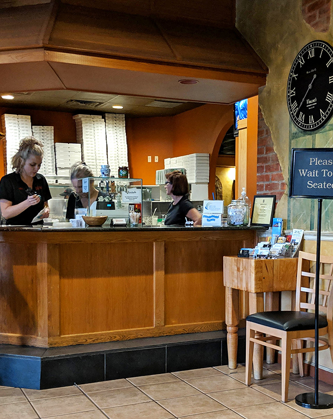 The heart of Vincent's hospitality begins at this welcoming counter &ndash; where staff orchestrate the dining experience with warmth and efficiency.