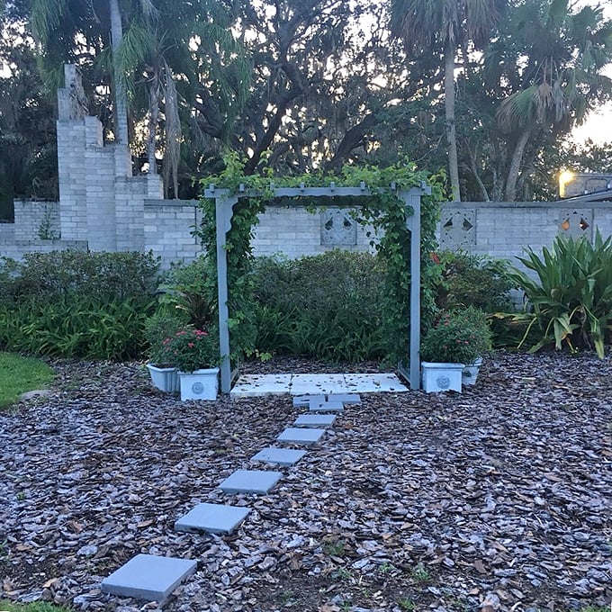 This humble garden arbor waits for climbing vines to complete its story, a quiet architectural moment amid the museum's more dramatic spaces.