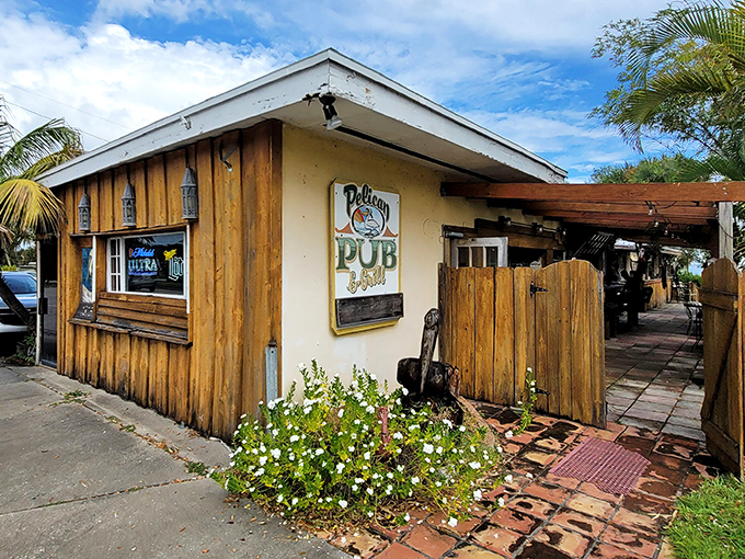 The Pelican Pub's weathered wood exterior tells stories of countless sunsets, cold beers, and friendships forged over both.