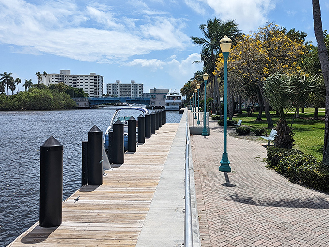 Veterans Park's waterfront walkway offers tranquil respite from beach crowds, where lamp posts stand like sentinels along the Intracoastal.