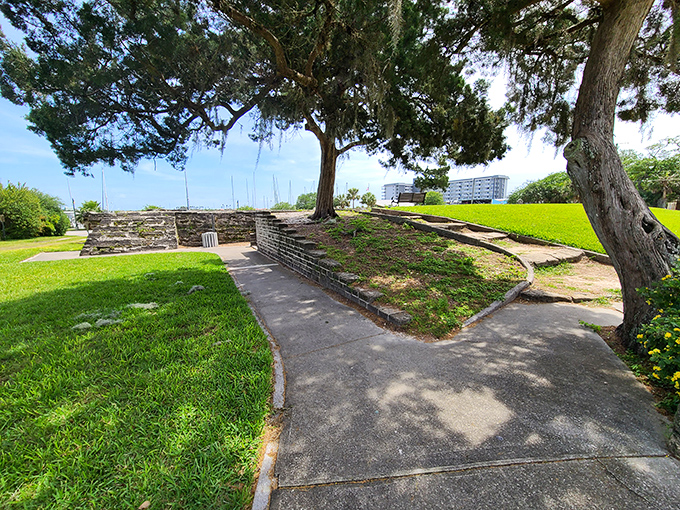 Manicured lawns frame centuries-old ruins, creating a surreal juxtaposition between weekly landscaping schedules and timeless historical preservation.