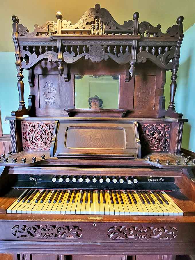 This antique pump organ whispers of hymns and parlor songs past, its ornate woodwork a testament to craftsmanship rarely seen in modern instruments.
