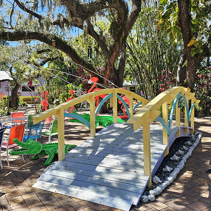 A charming yellow bridge arches over the garden path &ndash; not because there's water to cross, but because bridges make everything more magical.