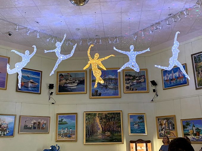 Suspended dancers float across the ceiling like artistic astronauts, proving that in this museum, even gravity takes a creative holiday.