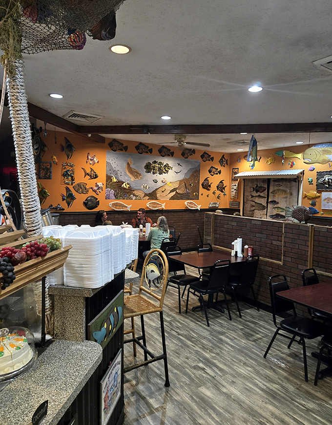 The dining area's walls serve as an underwater gallery, with colorful fish mounts creating a whimsical atmosphere that's pure Florida charm.