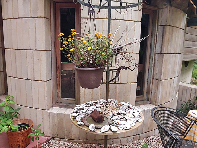 Shell-decorated tables and hanging planters bring whimsical touches to the exterior patio – Florida's natural elements incorporated into daily life.