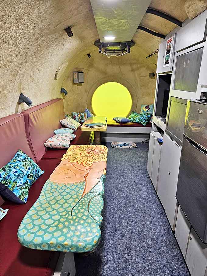 The main living area combines submarine-like efficiency with homey touches, creating a surprisingly comfortable underwater retreat.
