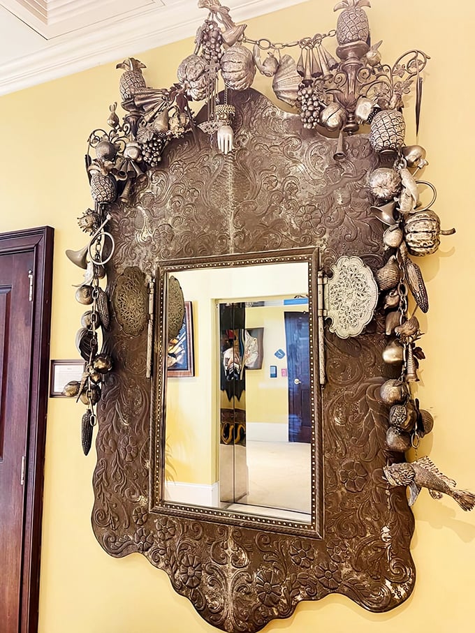 This mirror doesn't just reflect your image &ndash; it frames it in a metallic masterpiece that's part functional object, part wearable art collection.