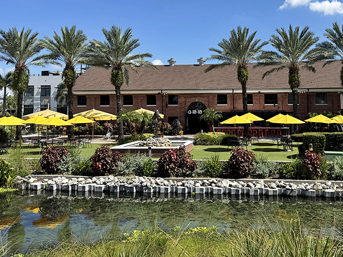Ulele's outdoor space offers a tranquil riverside retreat, where palm trees sway and yellow umbrellas provide shade for al fresco dining.
