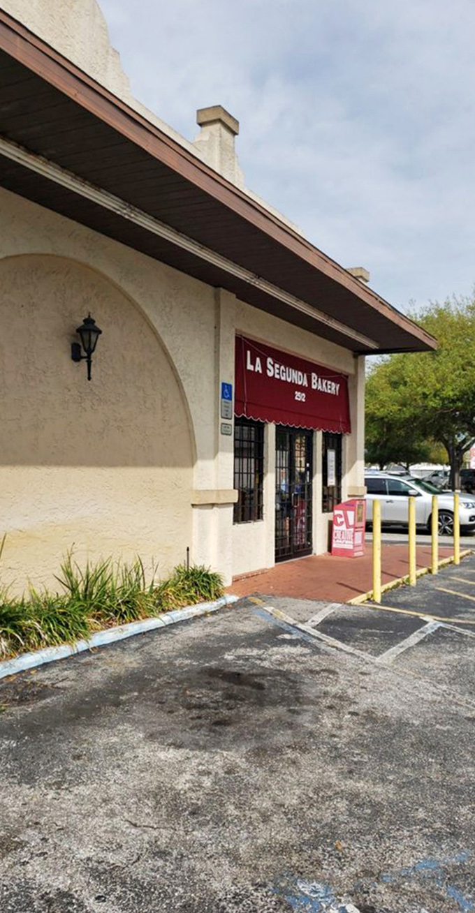 The welcoming entrance with its distinctive red awning invites passersby to step into a world of Cuban baking tradition.