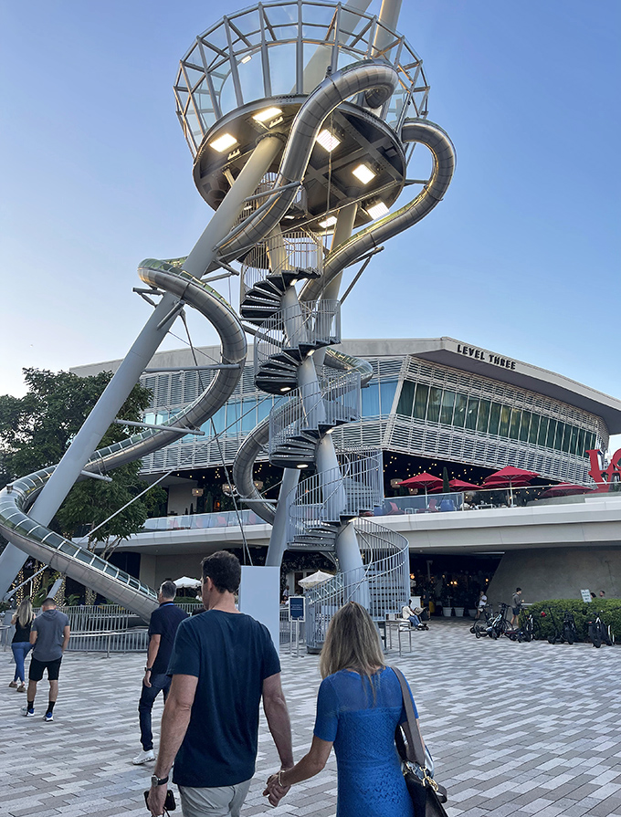 Visitors circle the installation like planets orbiting a metallic sun, perhaps wondering about the source of all those delighted screams.