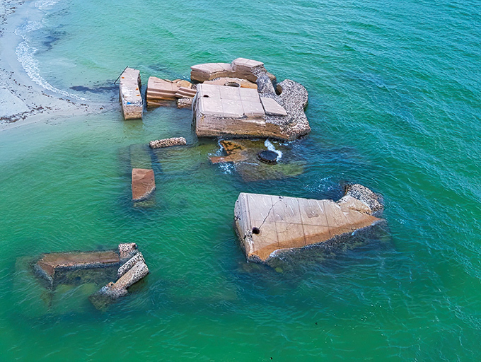 Military engineering meets artistic decay as Fort De Soto's remains create a haunting silhouette against crystal waters &ndash; history's stubborn refusal to disappear.