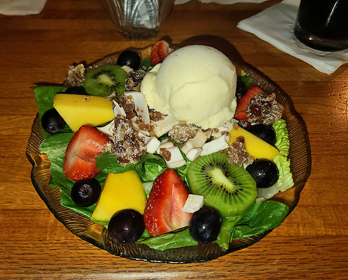 A feast for both eyes and palate &ndash; vibrant fruits, crisp greens, and creamy ice cream create a textural adventure in every bite.