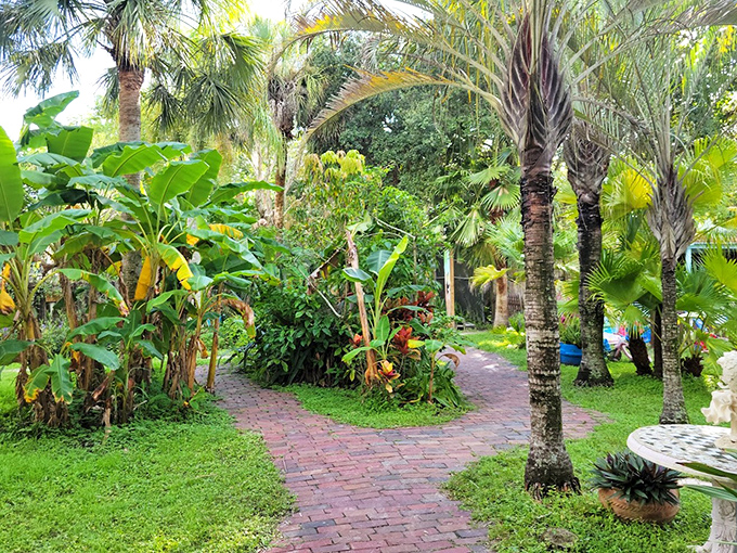 Sanctuary grounds: Nature reclaims this peaceful haven where palm fronds create dappled sunlight on pathways that invite visitors to slow down and simply be.