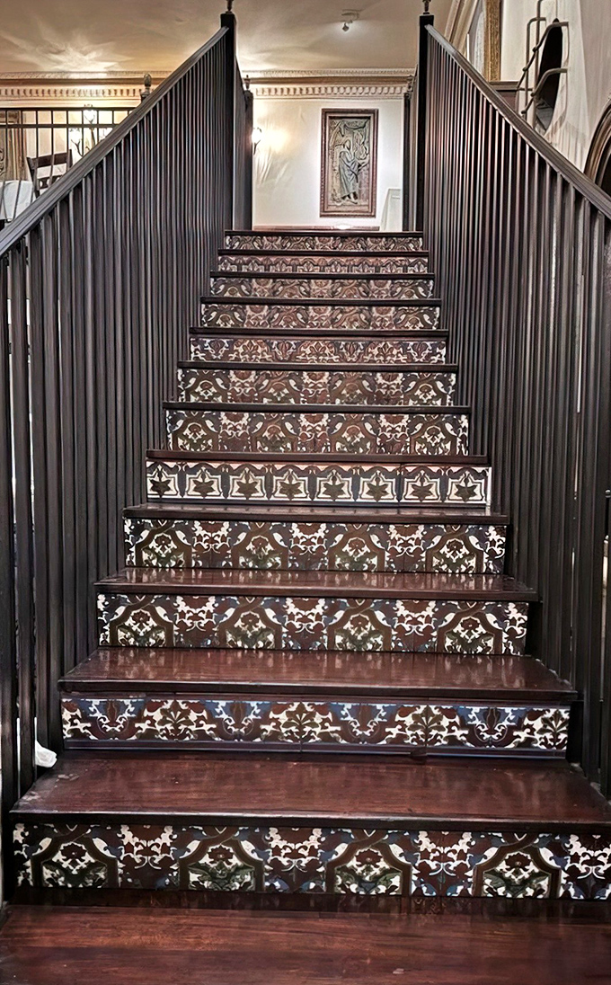 These ornate tiled stairs have carried countless patrons between dining rooms, each step a small journey through Spanish artistry and craftsmanship.
