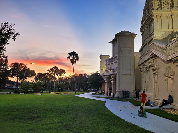 As the sun sets behind the temple, the white stone takes on amber hues, creating a magical twilight atmosphere that feels both ancient and timeless.