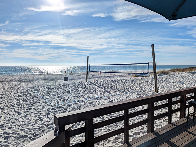The million-dollar vista from Sharky's deck &ndash; endless Gulf waters meeting blue sky, with volleyball nets ready for post-meal games.