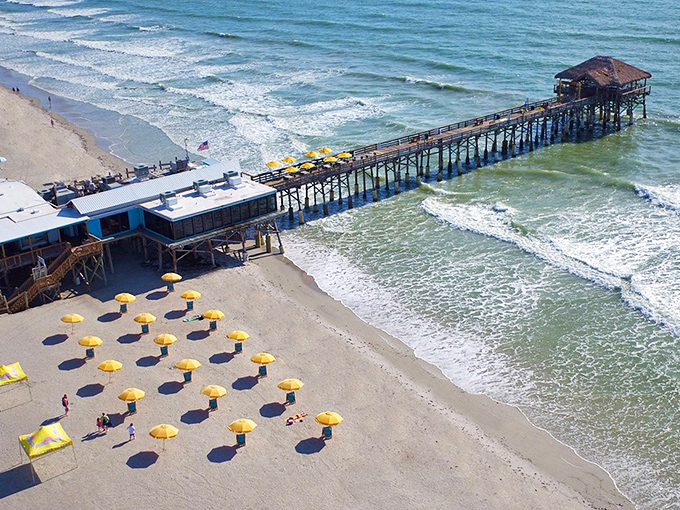 What an amazing shot! The pier stretching out over the Atlantic, with those bright umbrellas waiting&mdash;it's a perfectly organized slice of beach heaven.