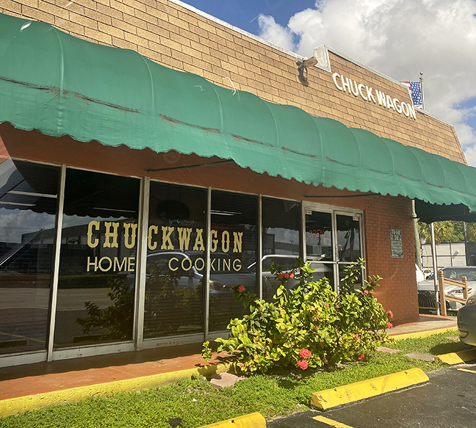 The green awning and straightforward signage at Chuck Wagon reflect its no-nonsense approach to delicious comfort food.