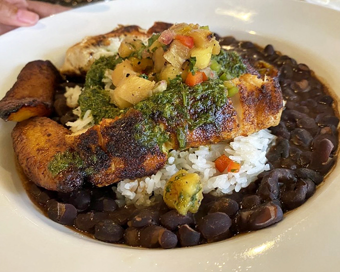 Blackened snapper rests atop a bed of rice and black beans &ndash; a dish that captures Florida's coastal bounty with every flavorful bite.