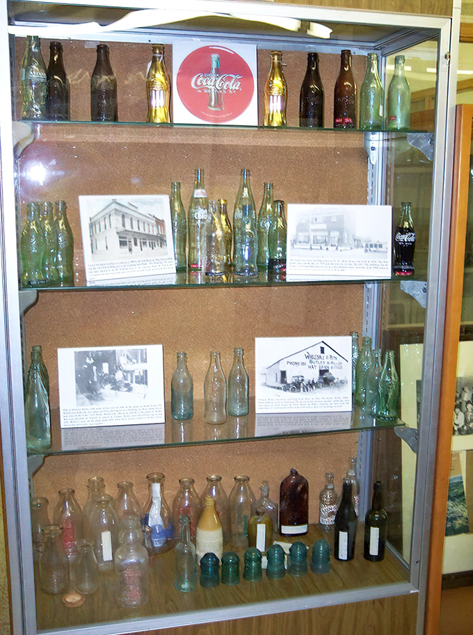 Vintage bottles line the shelves like liquid time capsules, each glass container telling stories of local businesses, family recipes, and bygone refreshments.