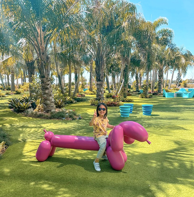 Childhood joy meets contemporary art in this playful pink balloon dog sculpture that delights visitors of all ages.