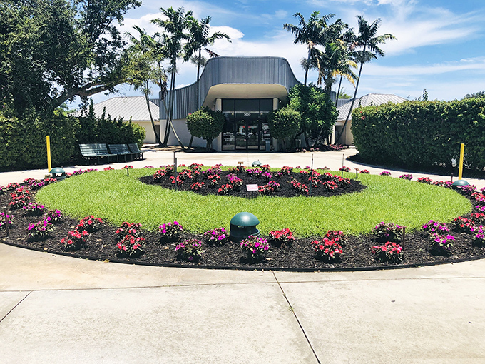 This perfectly manicured circular flower bed welcomes visitors with a pop of color. Florida gardening at its finest&mdash;where every plant has butterfly appeal.