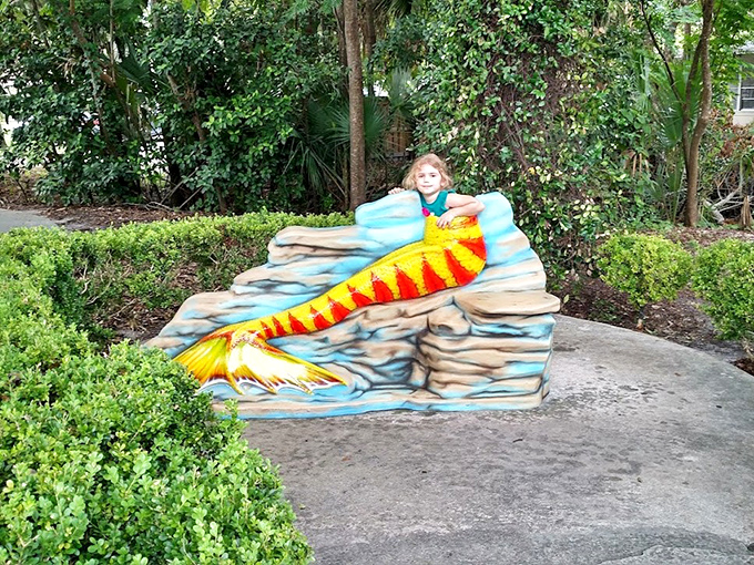 Children delight in posing with this vibrant mermaid tail sculpture, imagining their own underwater adventures in Weeki Wachee's springs.