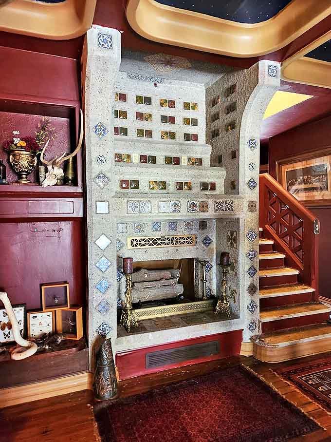 The interior fireplace isn't merely functional – it's a mosaic masterpiece that transforms a practical necessity into an artistic statement.